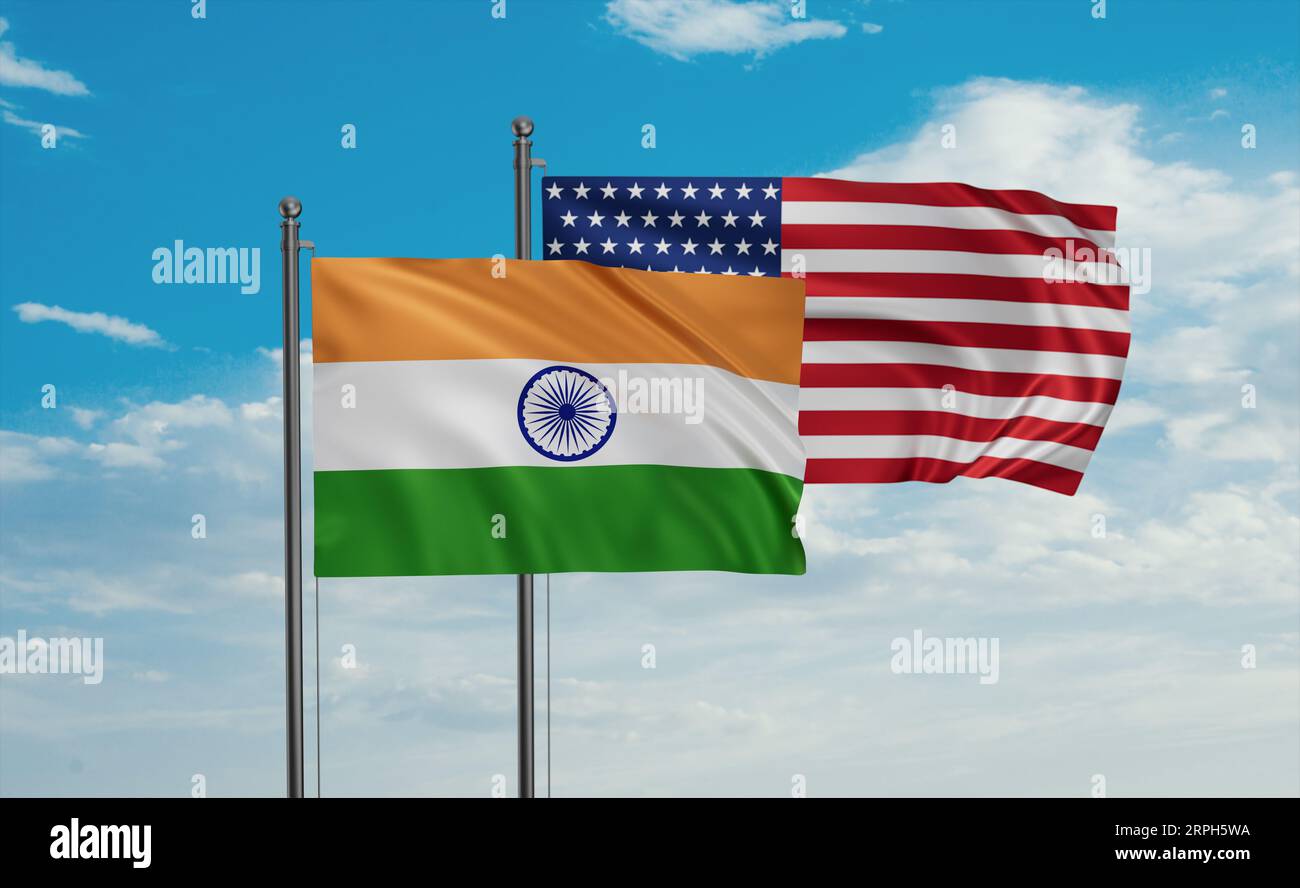 USA and India flag waving together in the wind on blue sky, two country ...