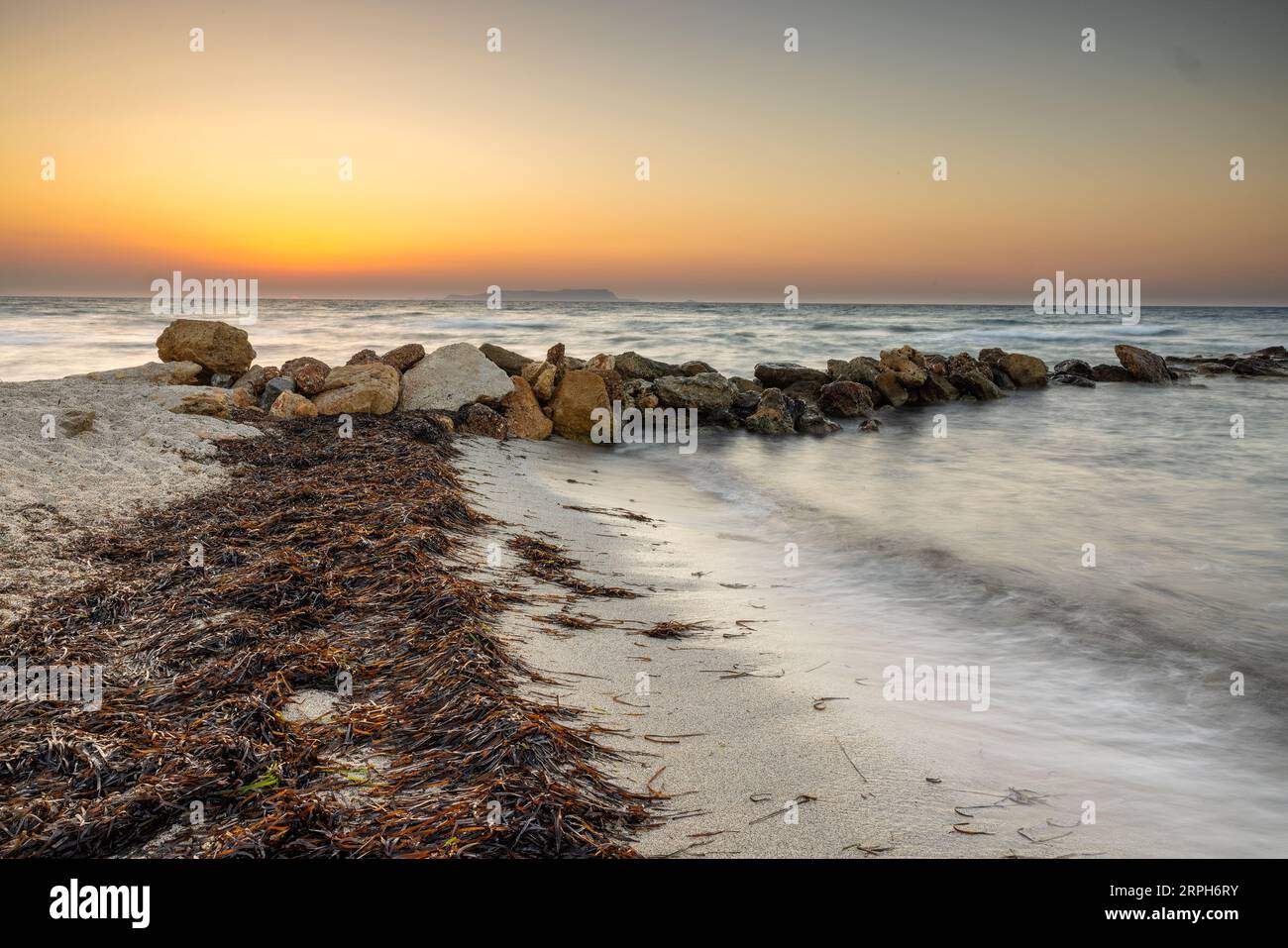 Step into a dreamscape by the coast, where a rocky breakwater meets a ...