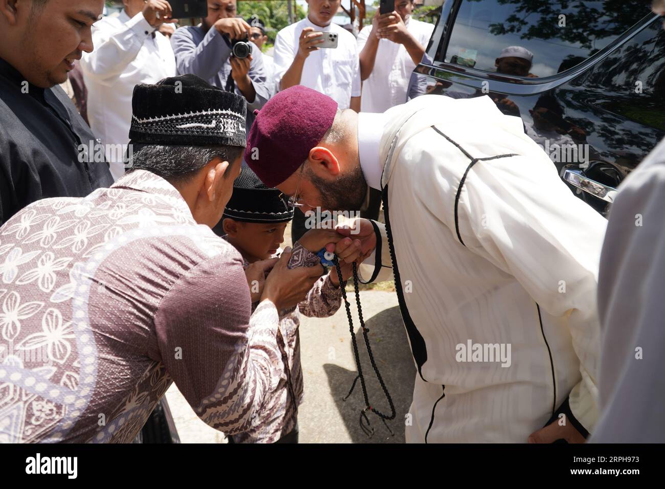 Sheikh Usama Elsayed Alazhary kissed the boy's in Aceh, Indonesia Stock ...