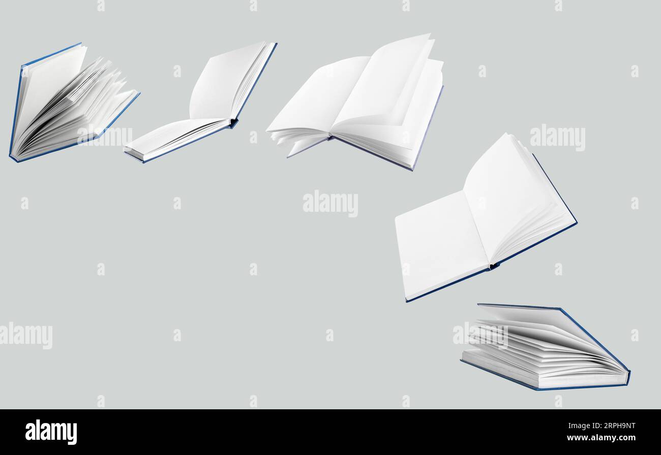 Many flying books on grey background Stock Photo - Alamy