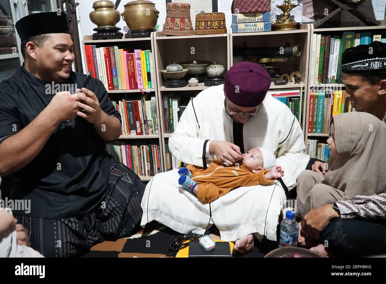 Sheikh Usama Elsayed Alazary tastes sweets for babies during Sheikh ...