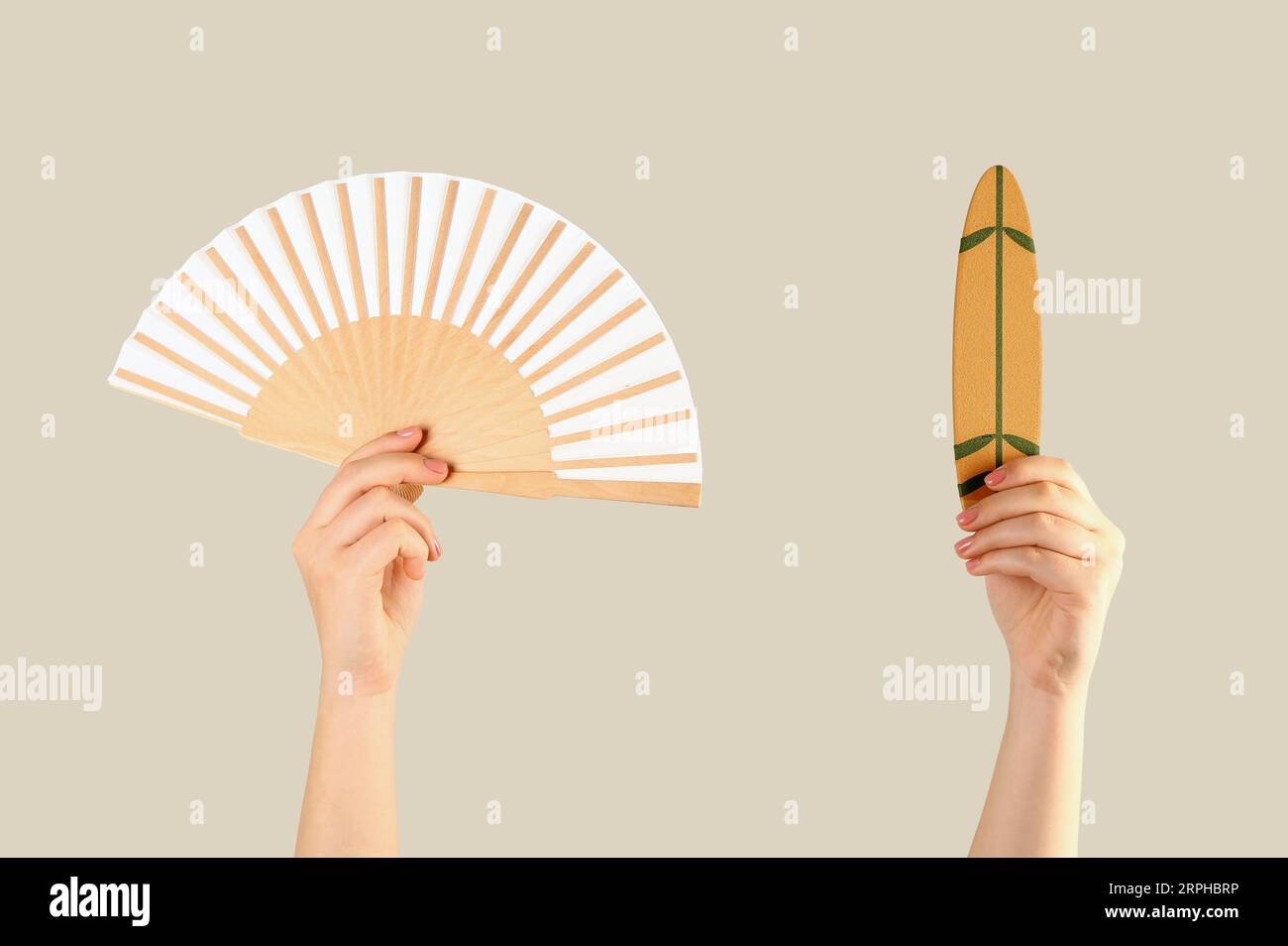 Female hands with mini surfboard and fan on grey background Stock Photo ...