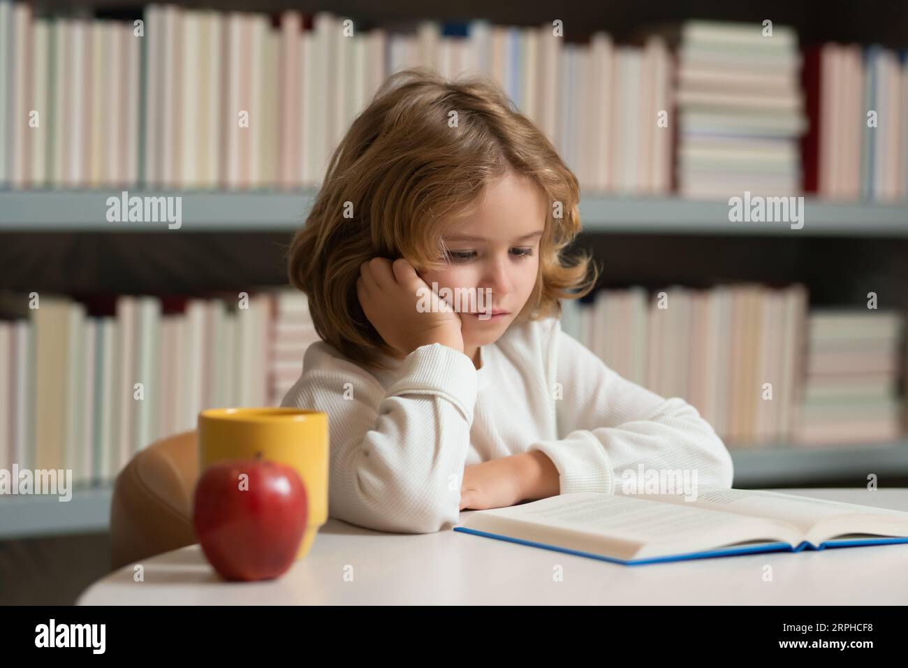 Little student read book. School pupil with pile of books. Children ...