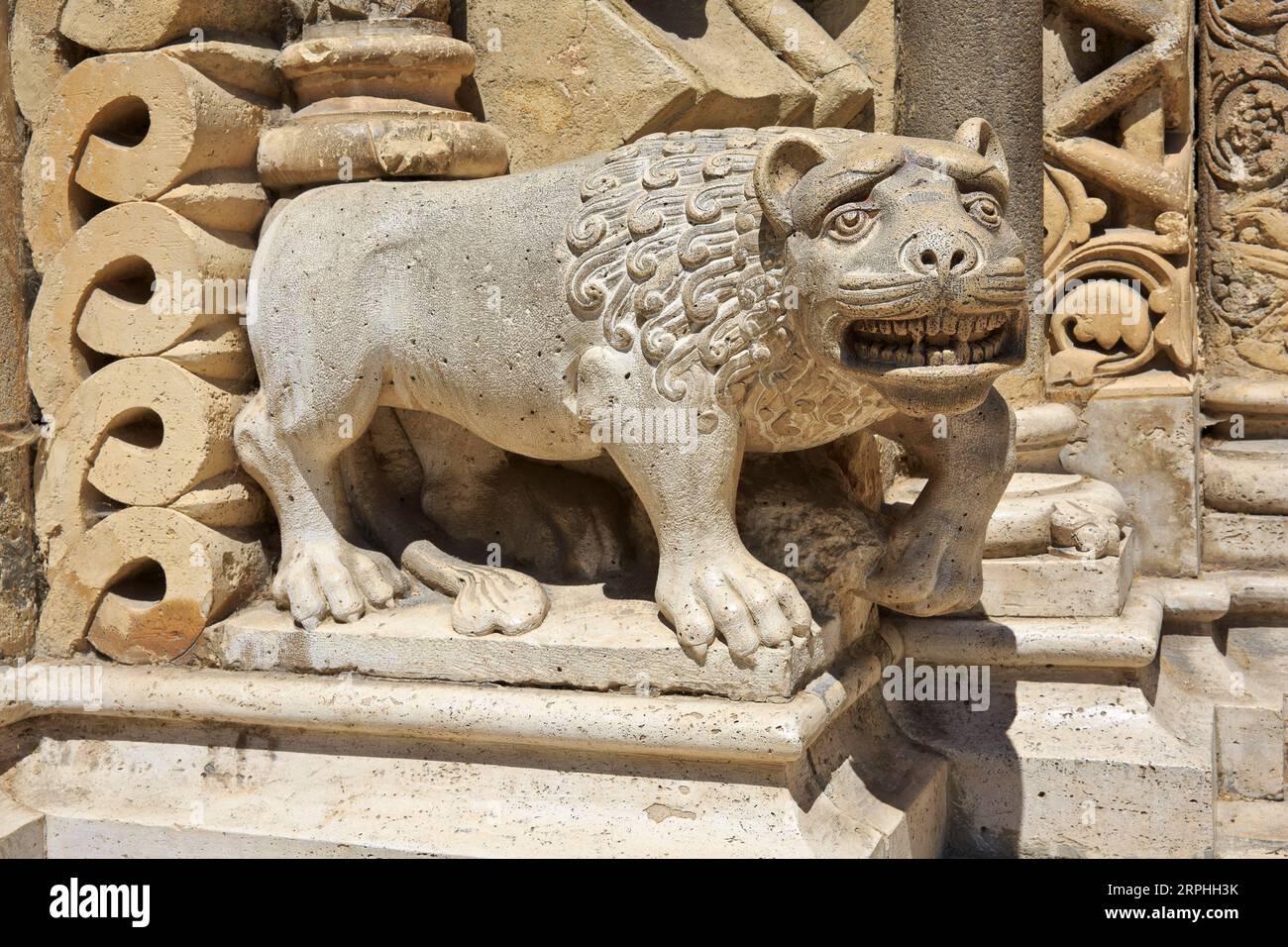 A carved lion flanking the entrance doors of the small Romanesque Jak ...