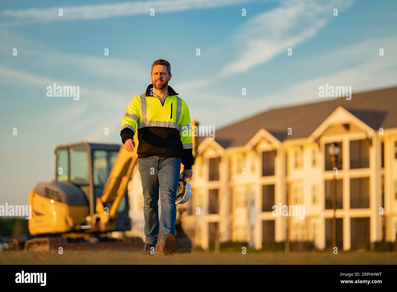 Builder with excavator for construction at the construction site ...
