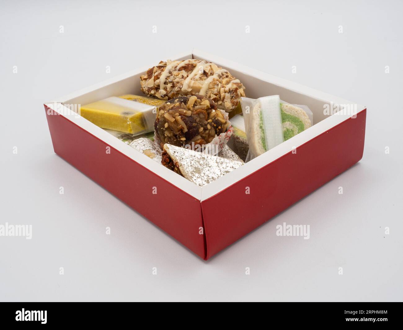 Angle view of a box with red sides filled with assorted, delectable ...