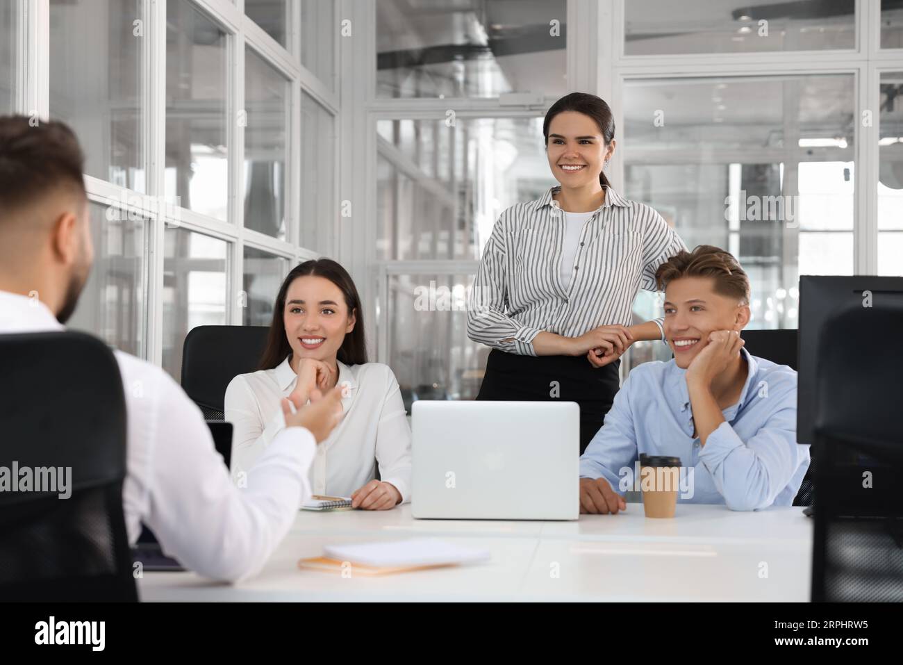 Colleagues working together in open plan office Stock Photo - Alamy