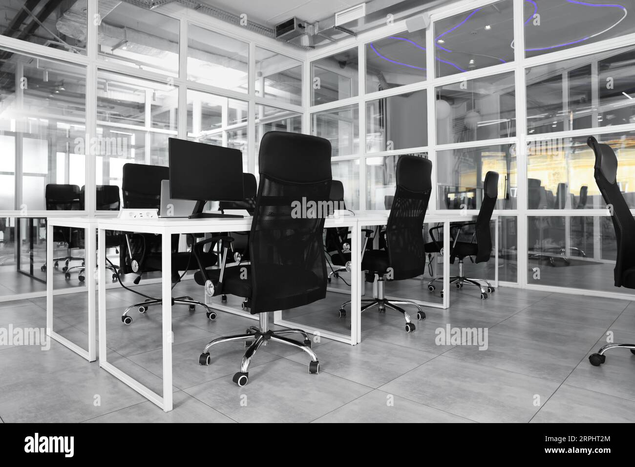 Stylish interior of open plan office. Workspace with computers, tables ...