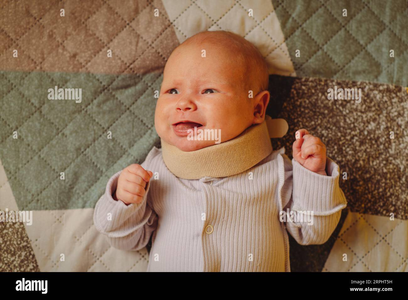 Cute newborn baby in a neck brace. Kid wearing cervical collar ...