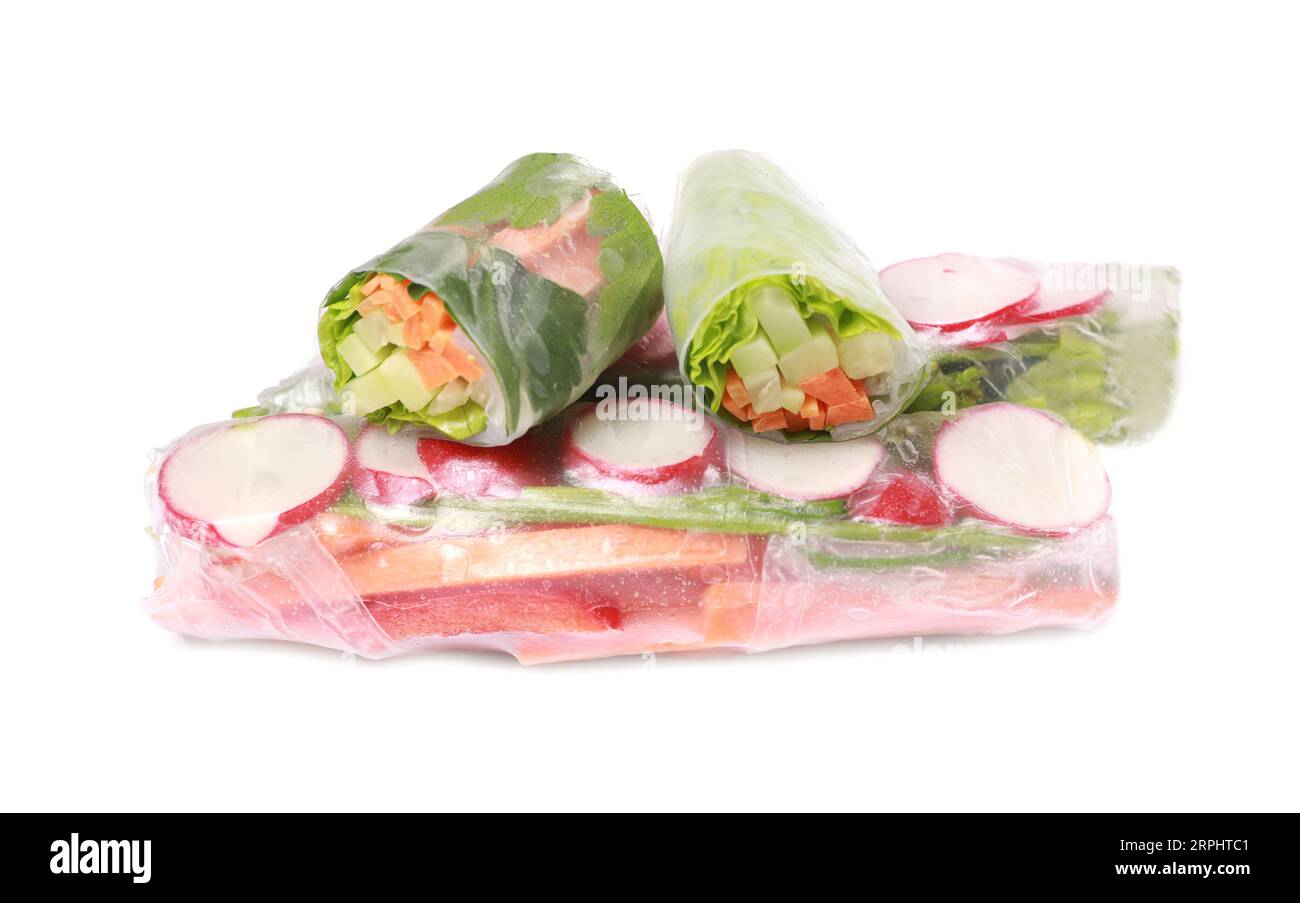Different delicious spring rolls wrapped in rice paper on white ...