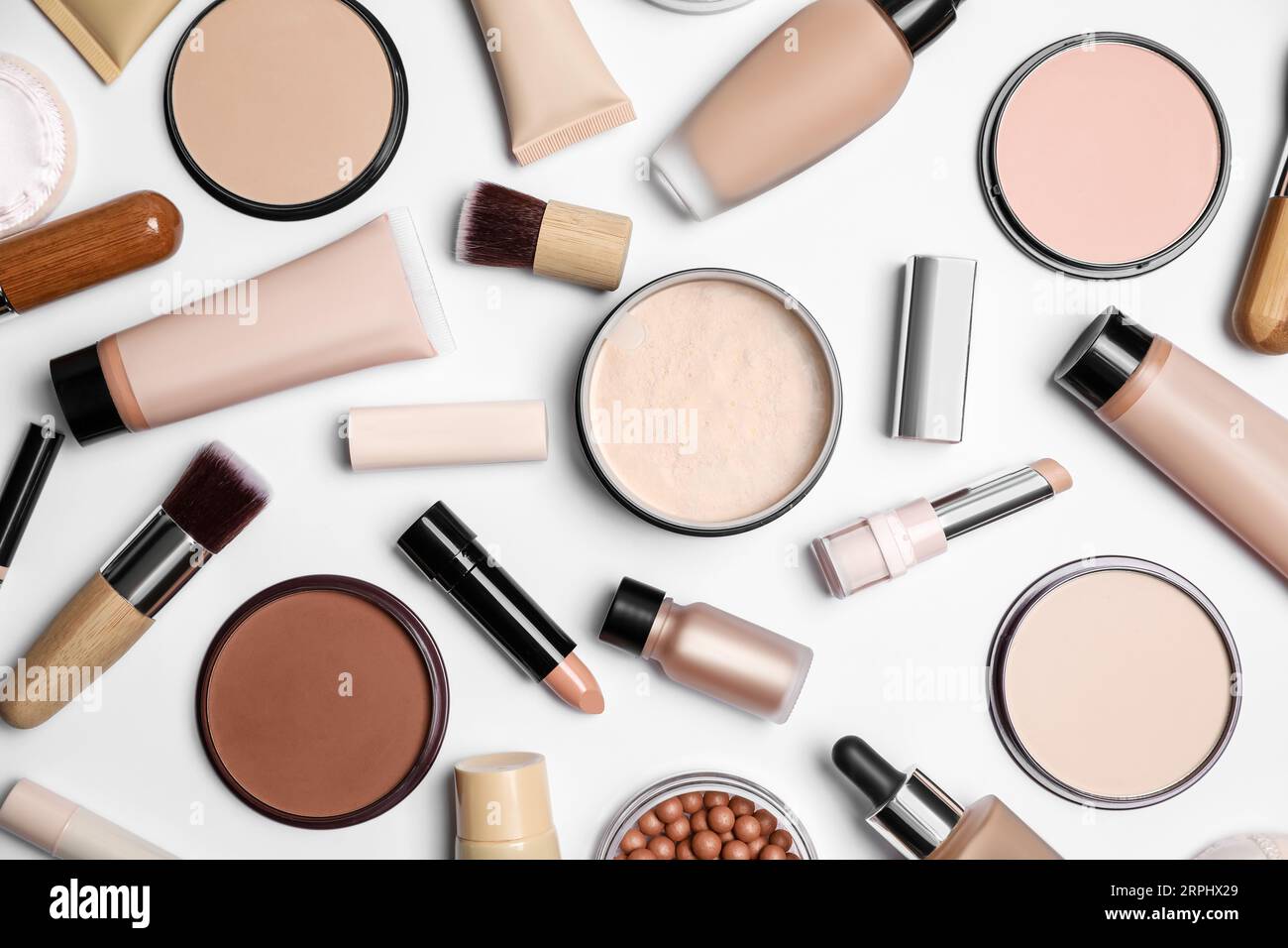 Face powders and other makeup products on white background, flat lay ...