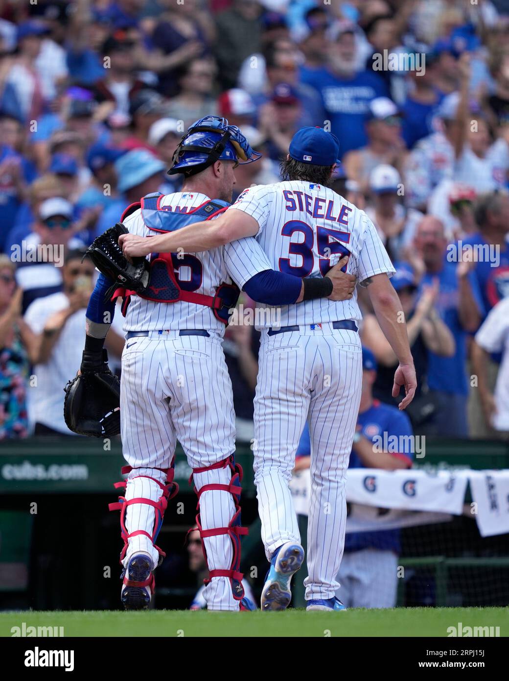 Chicago Cubs catcher Yan Gomes and starting pitcher Justin Steele walk off the field after ...