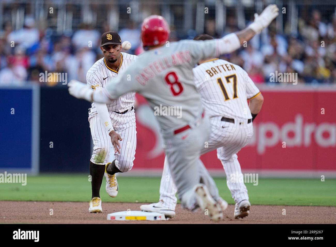 San Diego Padres shortstop Xander Bogaerts, left, tosses the ball to ...