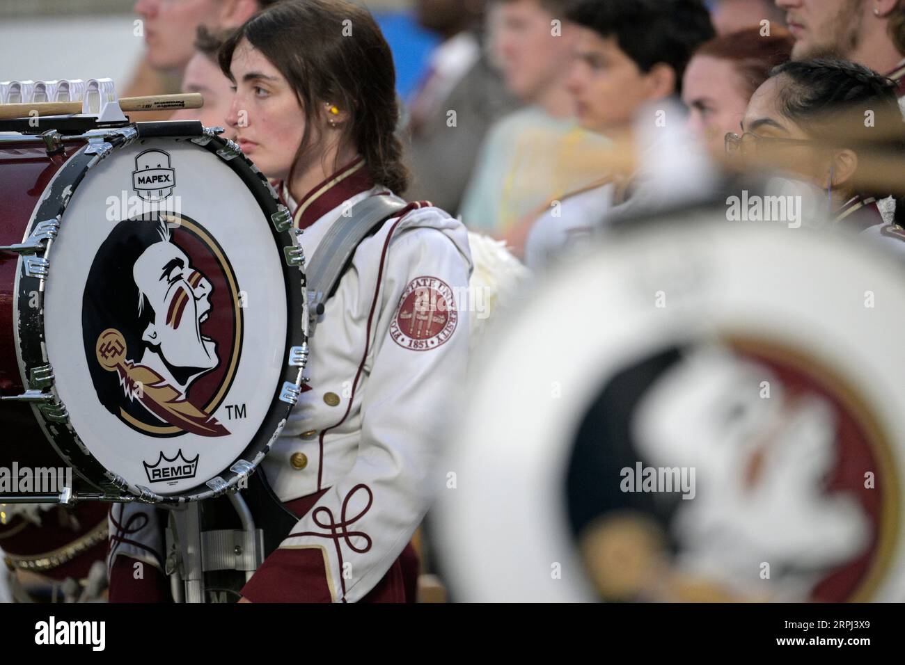 Florida State marching band members watch from the field after ...
