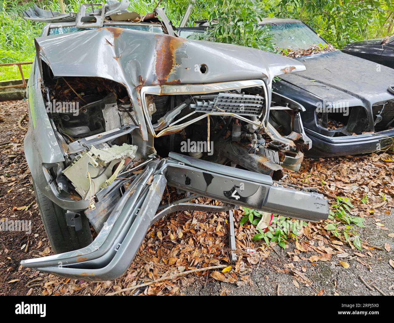 unrecognizable and wrecked cars beyond repair left at the isolated junk ...