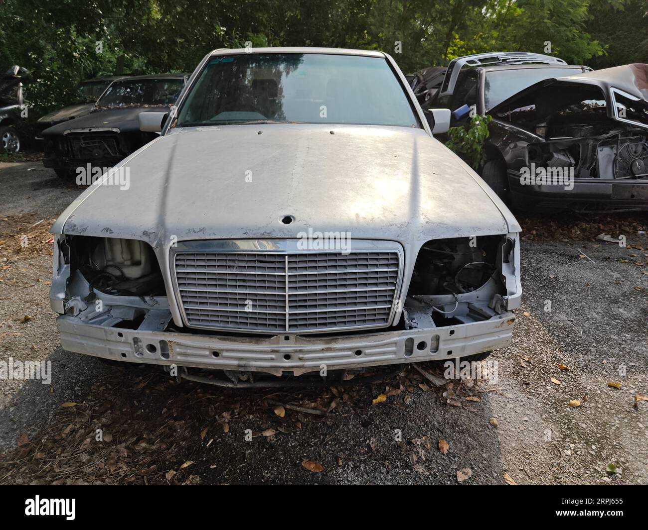 unrecognizable and wrecked cars beyond repair left at the isolated junk ...