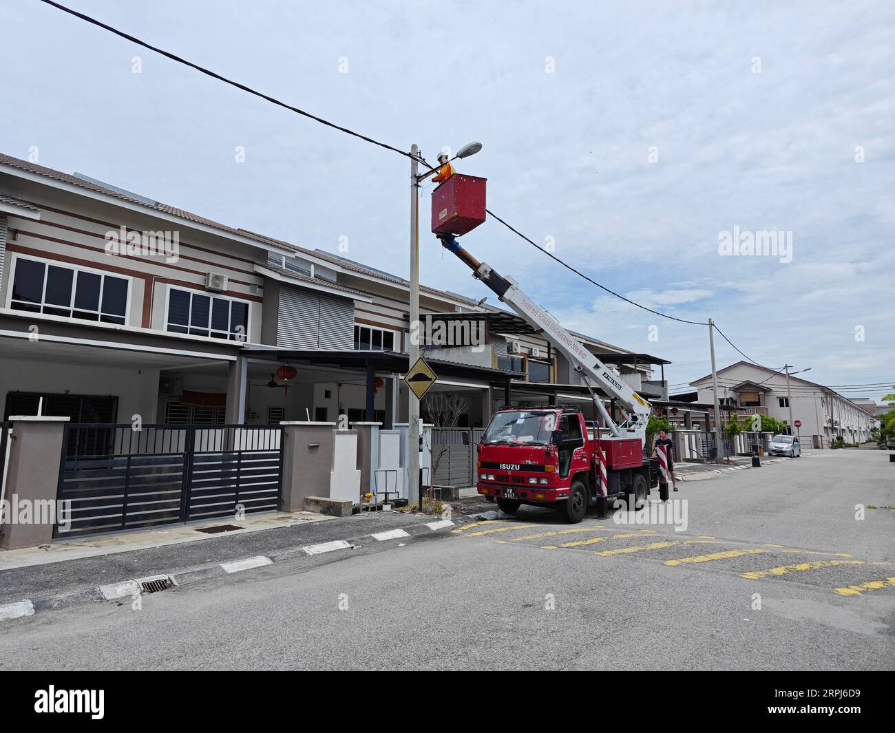 Outdoor scene of workers change streetlight bulb pole with the Rear ...
