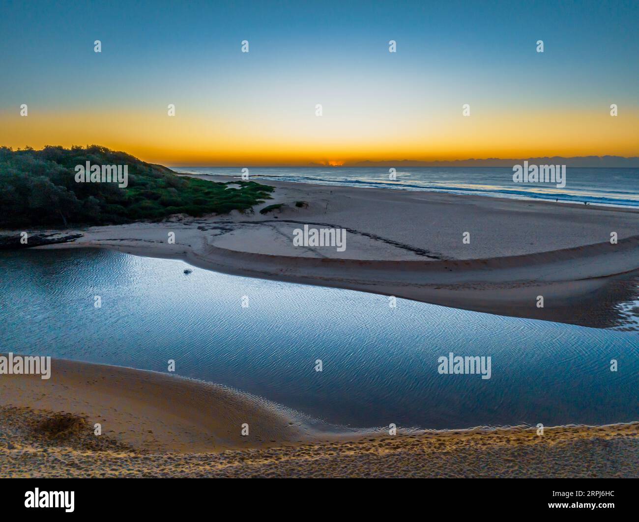 Aerial sunrise with the lagoon open to the sea at Wamberal Beach on the ...