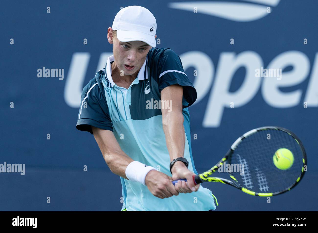 Cooper Williams of USA returns ball during 2nd round boys junior ...