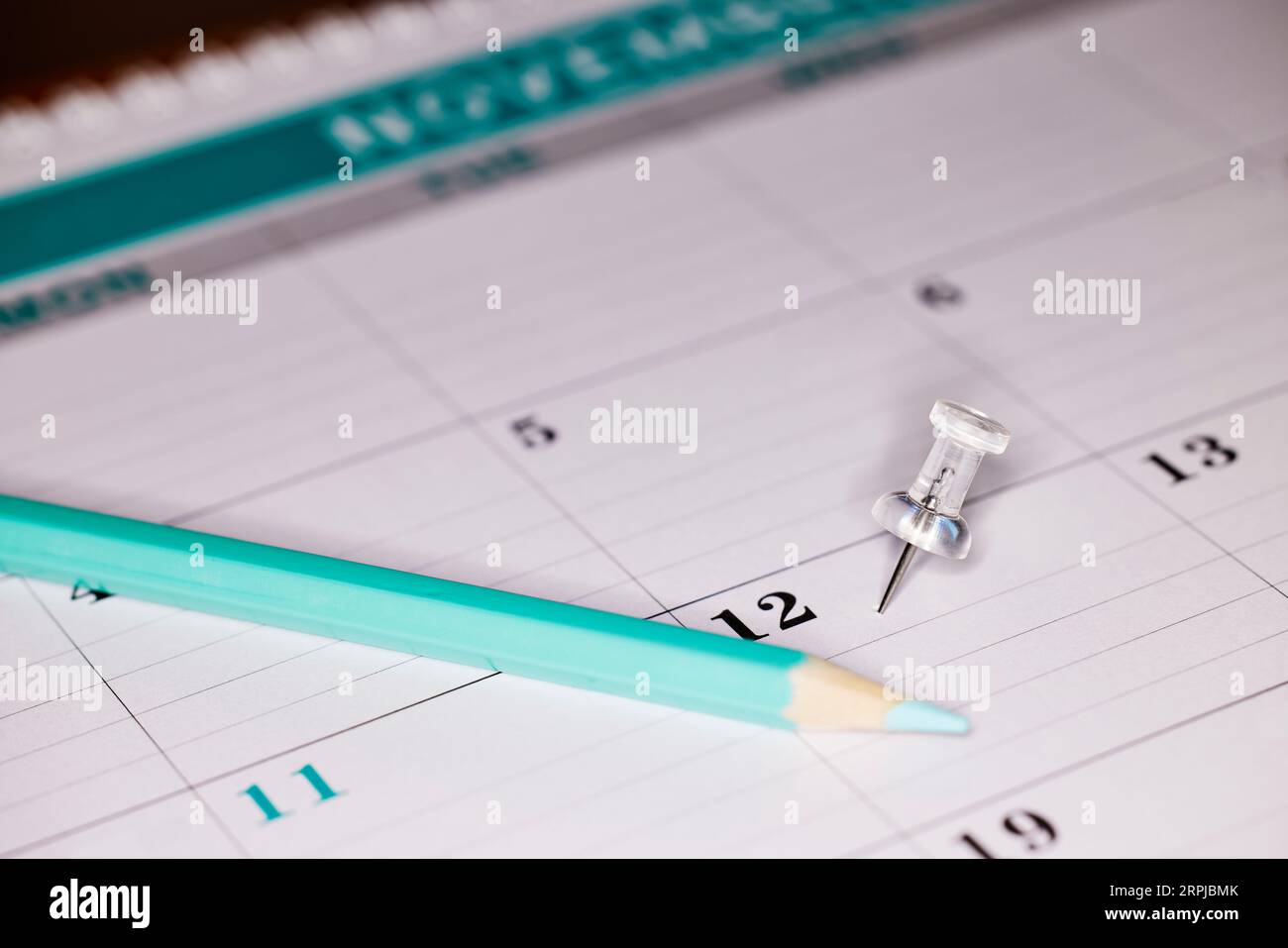 Close up of the days of the week on a calendar with a thumb tack on day ...