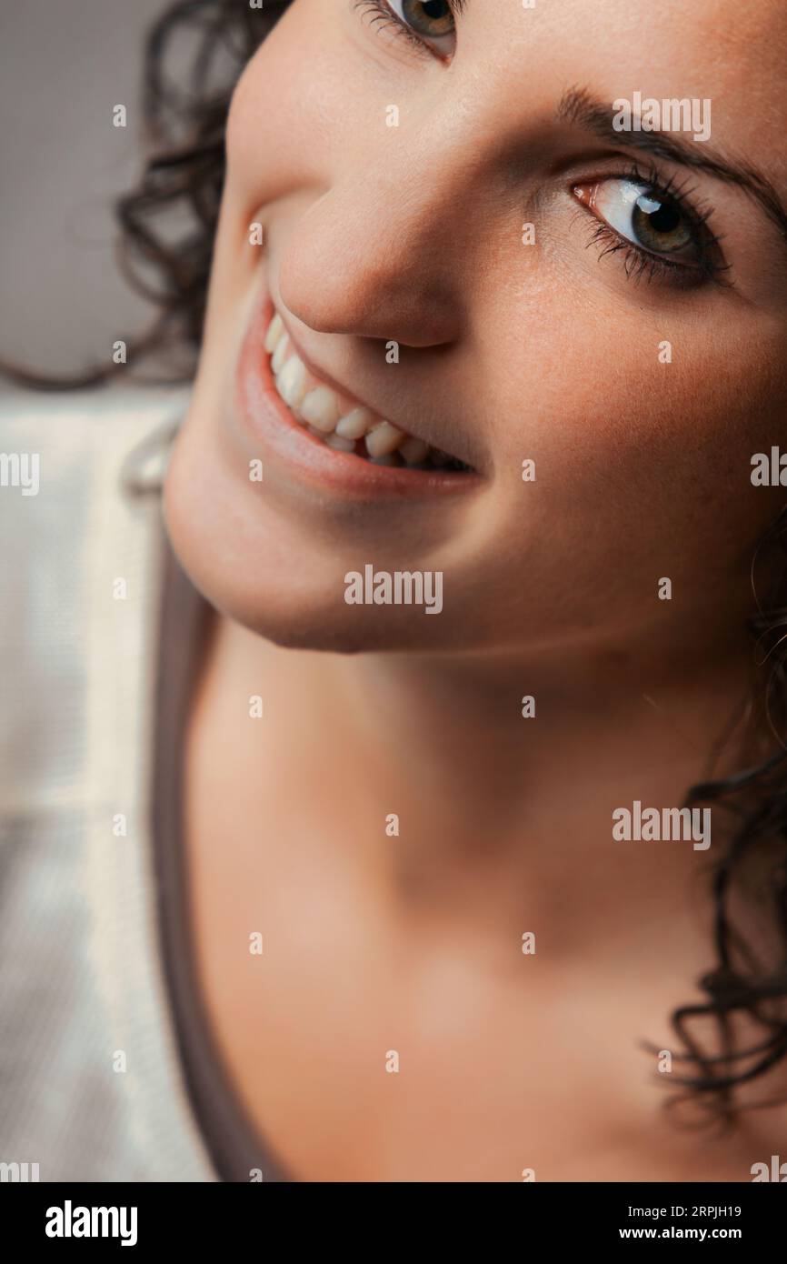 Portrait of a young woman with curls. The future, in her eyes, holds ...