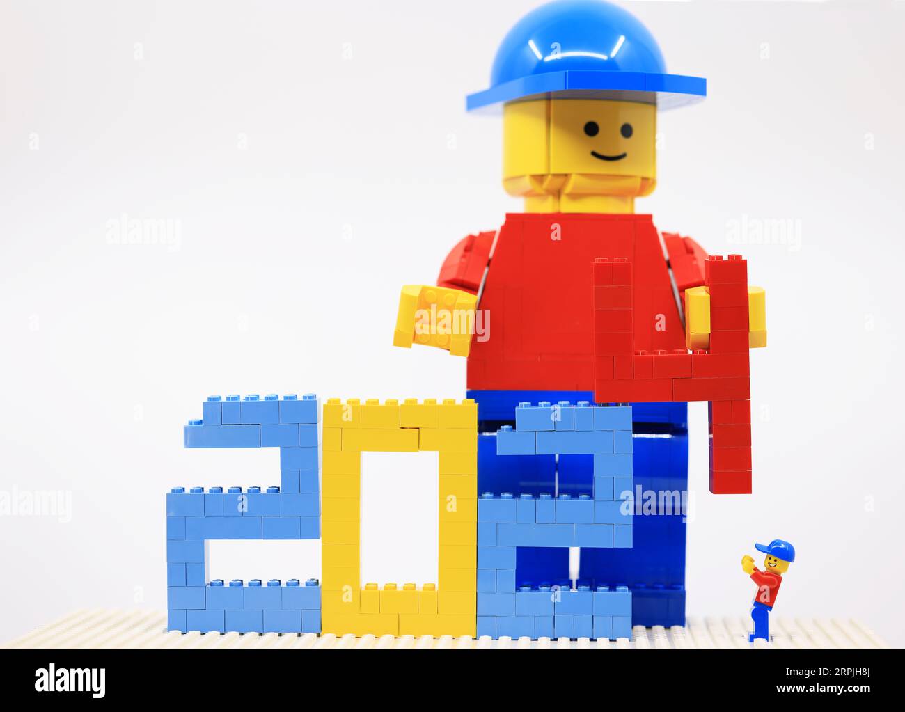 Giant man set up the new year 2024 wording Stock Photo - Alamy