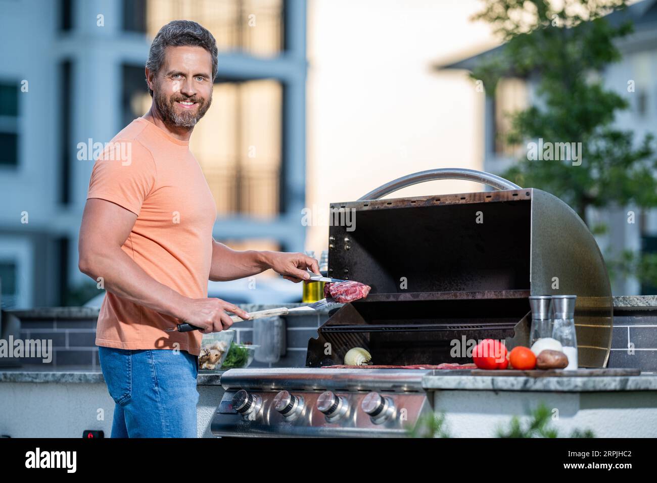 Grilling man cook meat at barbecue. Outdoor happy man cooking grill and ...