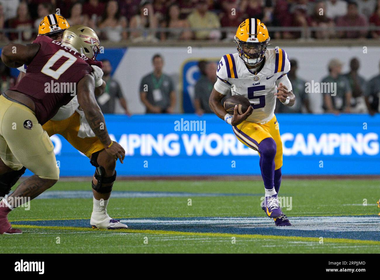 LSU quarterback Jayden Daniels (5) scrambles for yardage during the ...