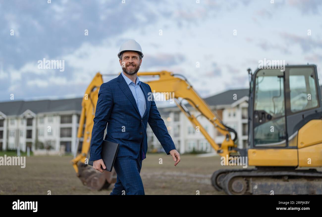photo of businessman with building plan wearing hardhat, banner ...