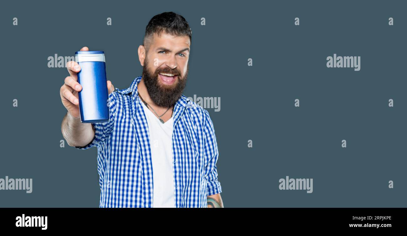 happy bearded guy hold male product of beard care cosmetics Stock Photo ...