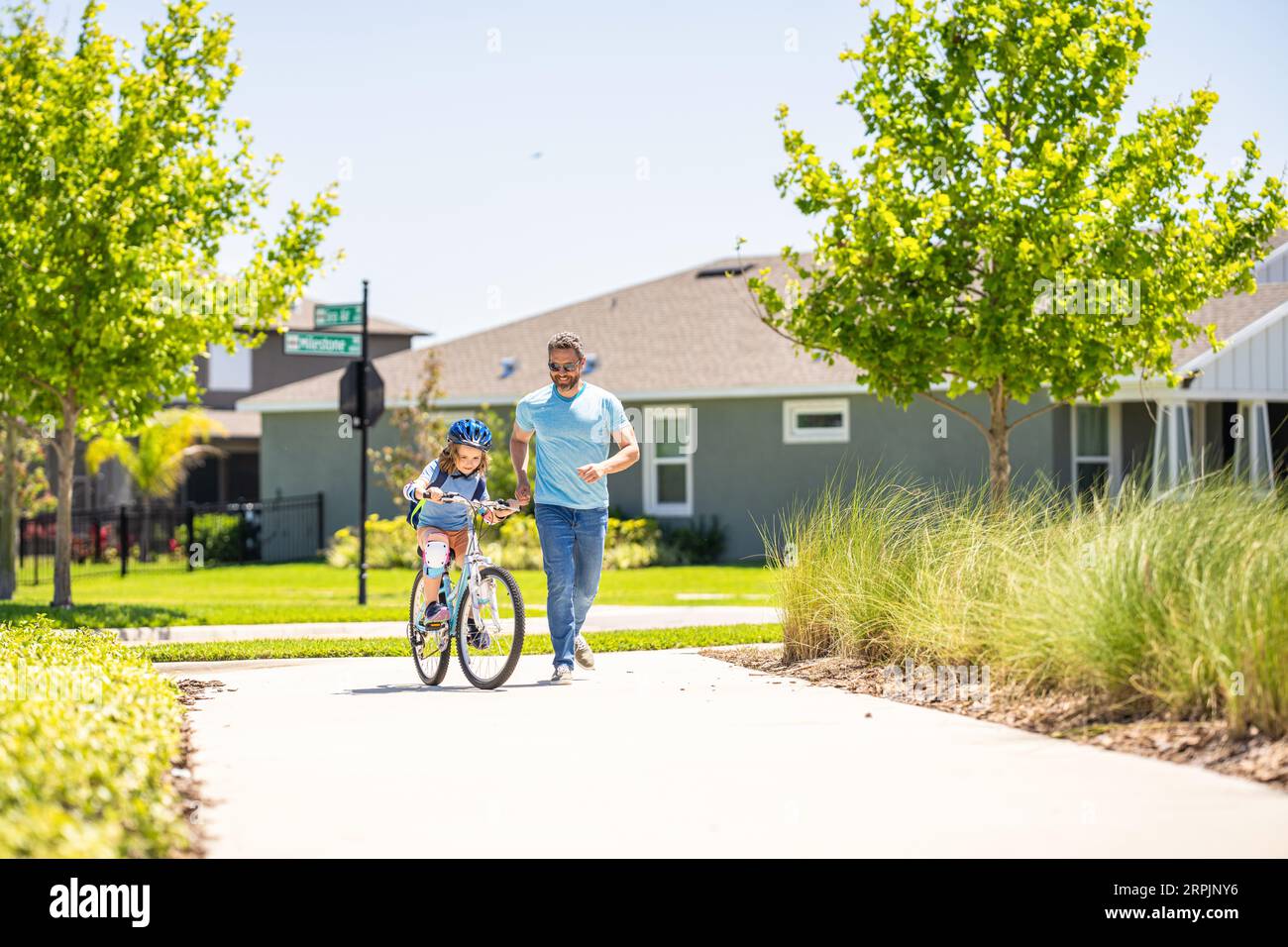 father and son on bicycle at fathers day. active father setting a ...