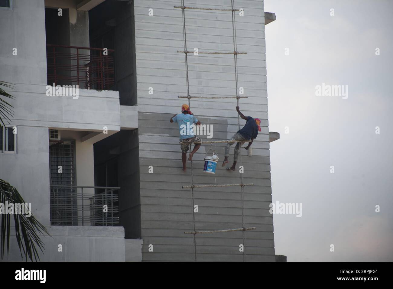 DHAKA Bangladesh September 05,2023. Workers paint a high-rise building ...