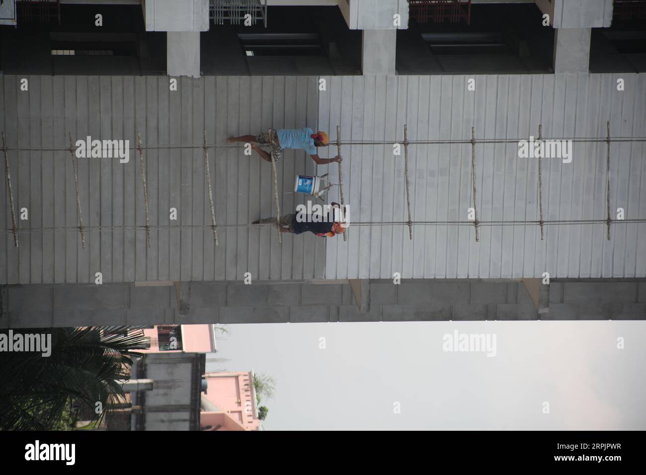 DHAKA Bangladesh September 05,2023. Workers paint a high-rise building ...