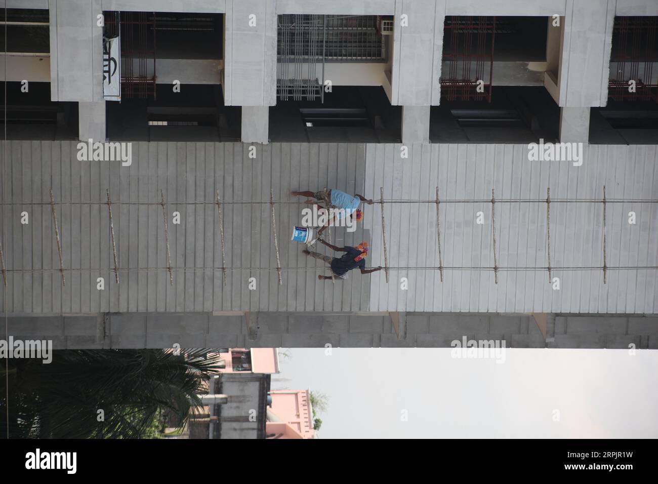 DHAKA Bangladesh September 05,2023. Workers paint a high-rise building ...