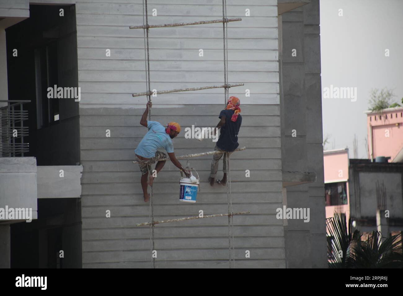DHAKA Bangladesh September 05,2023. Workers paint a high-rise building ...