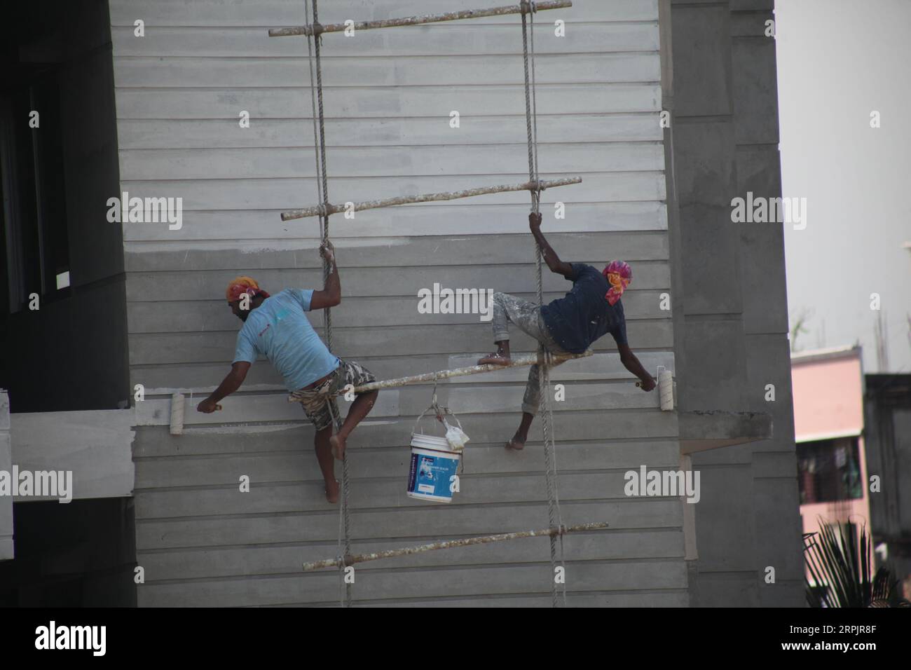 DHAKA Bangladesh September 05,2023. Workers paint a high-rise building ...