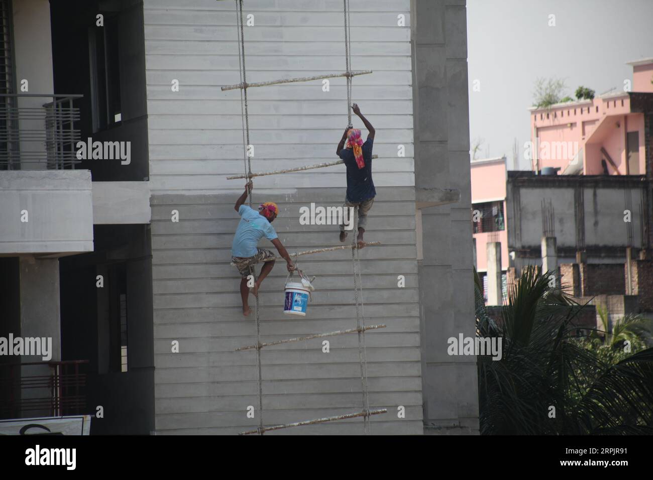 DHAKA Bangladesh September 05,2023. Workers paint a high-rise building ...