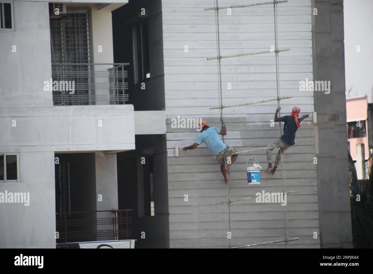 DHAKA Bangladesh September 05,2023. Workers paint a high-rise building ...