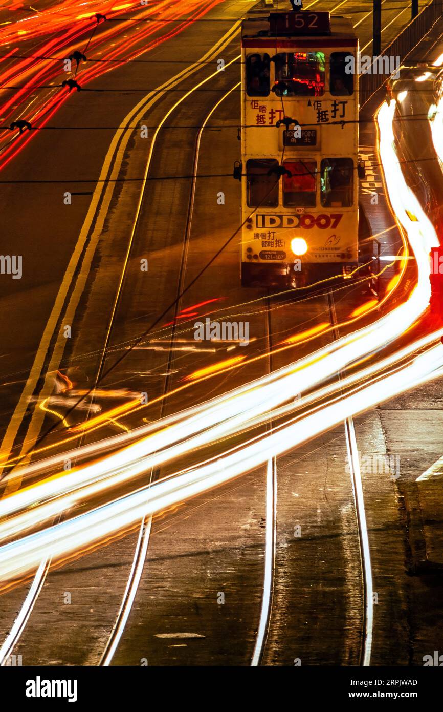 Light trails, traffic signals, tram, at night in Admiralty, Hong Kong ...