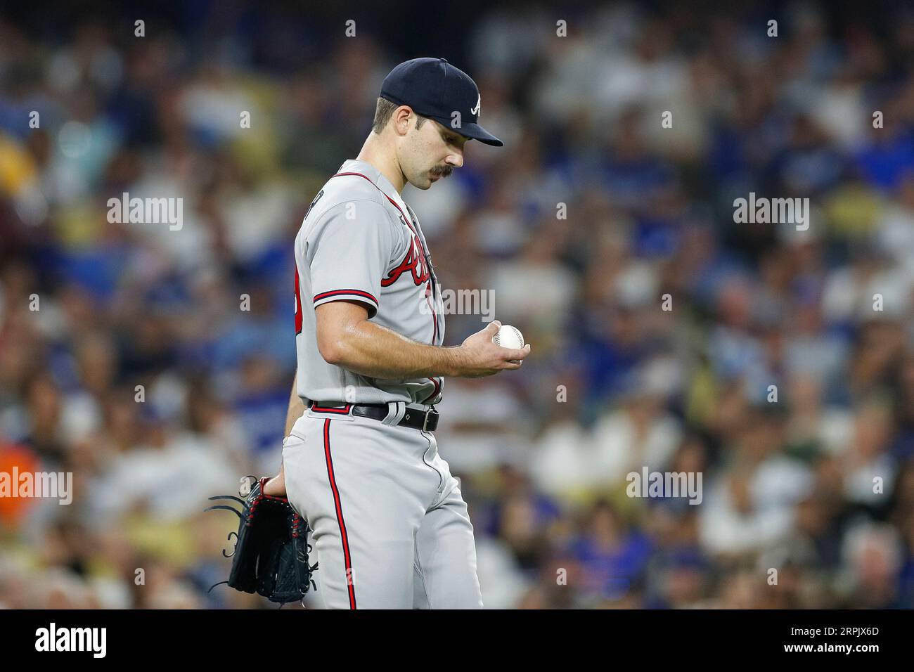 Atlanta Braves starting pitcher Spencer Strider (99) inspects a ball ...