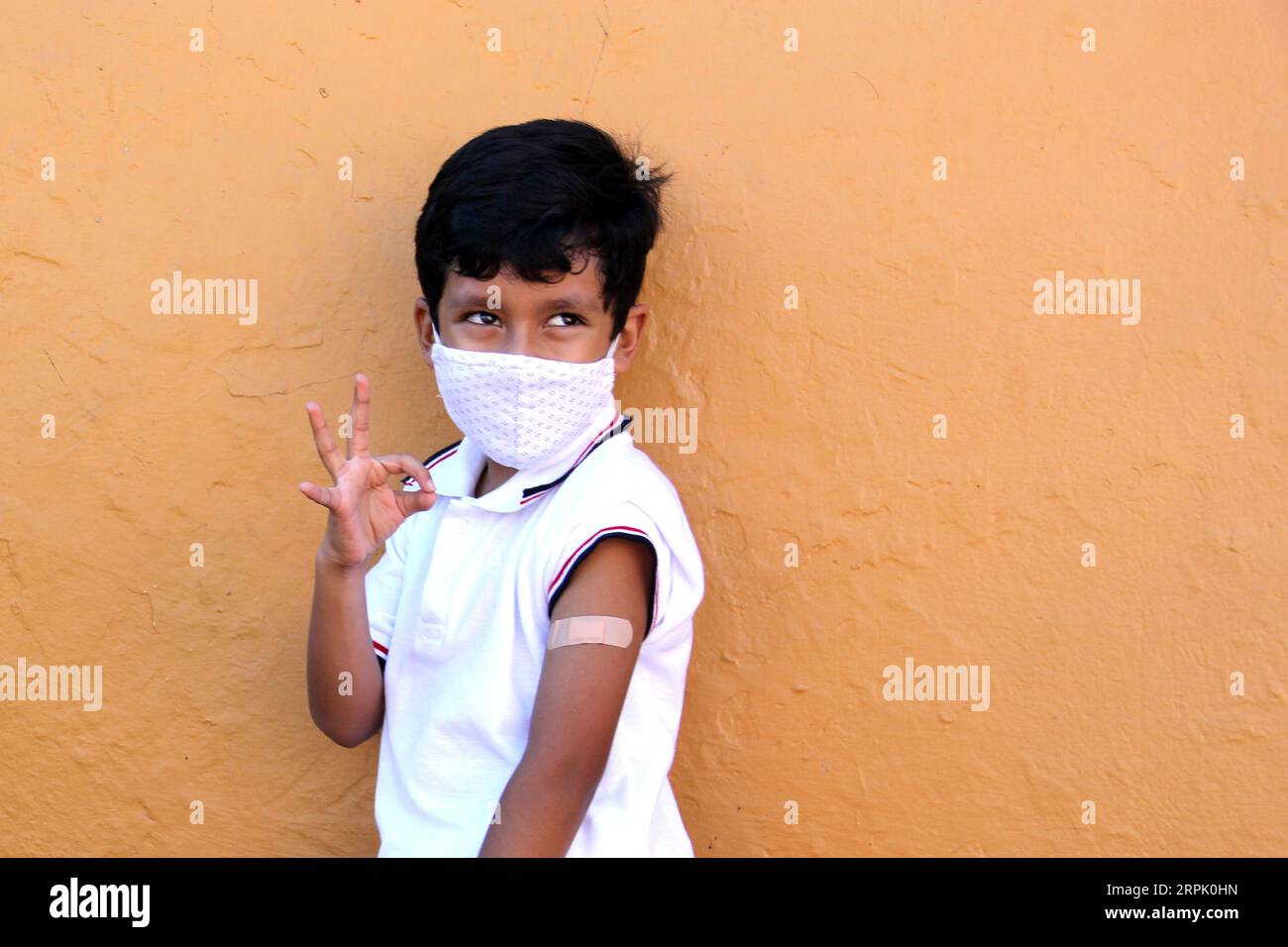7-year-old Latino boy with black hair in a school uniform shirt and ...