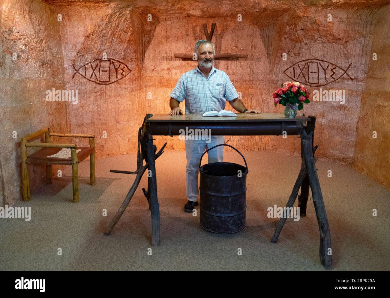 An Anglican priest at the altar made from a mining windlass in an ...