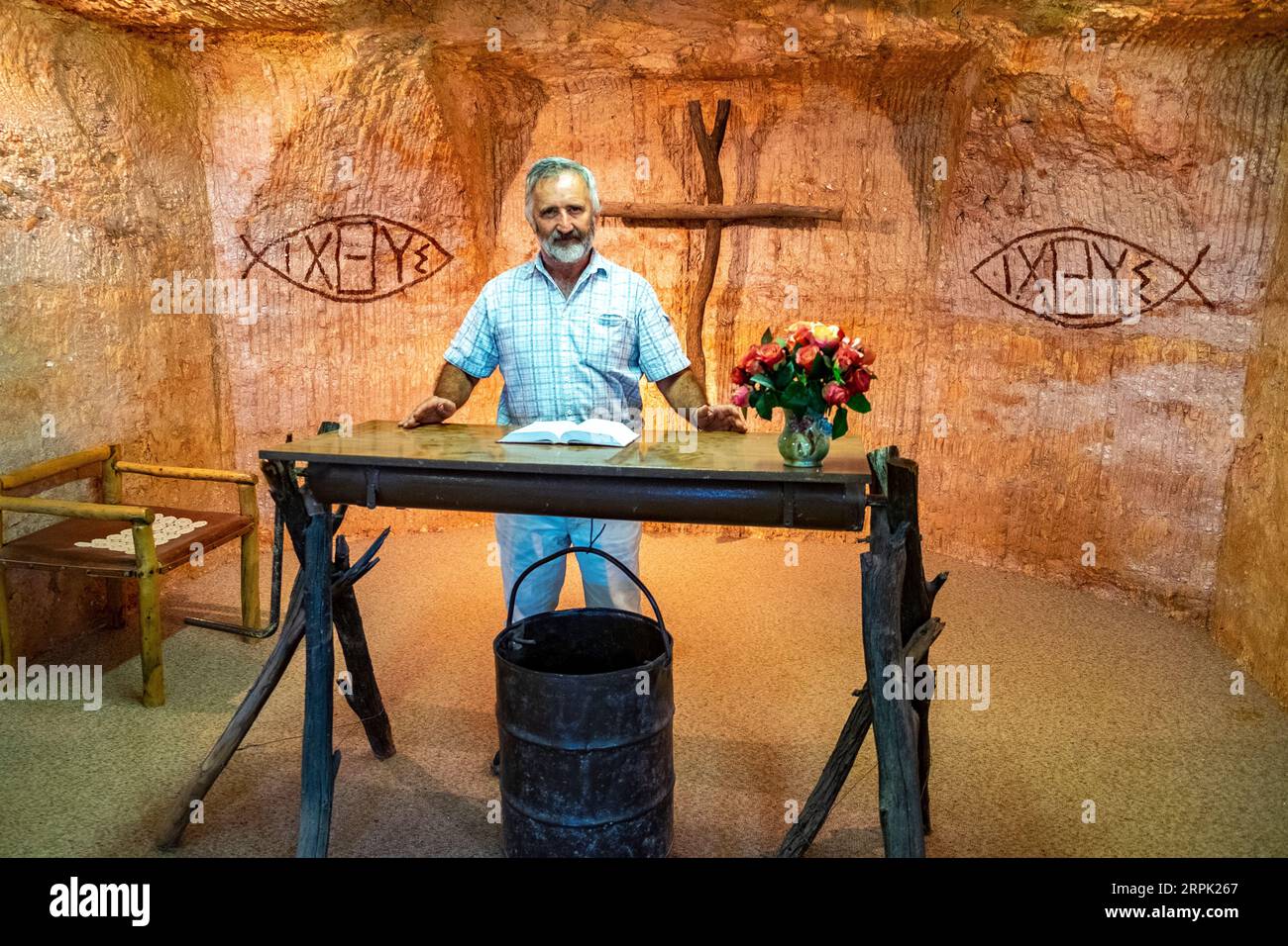 An Anglican priest at the altar made from a mining windlass in an ...