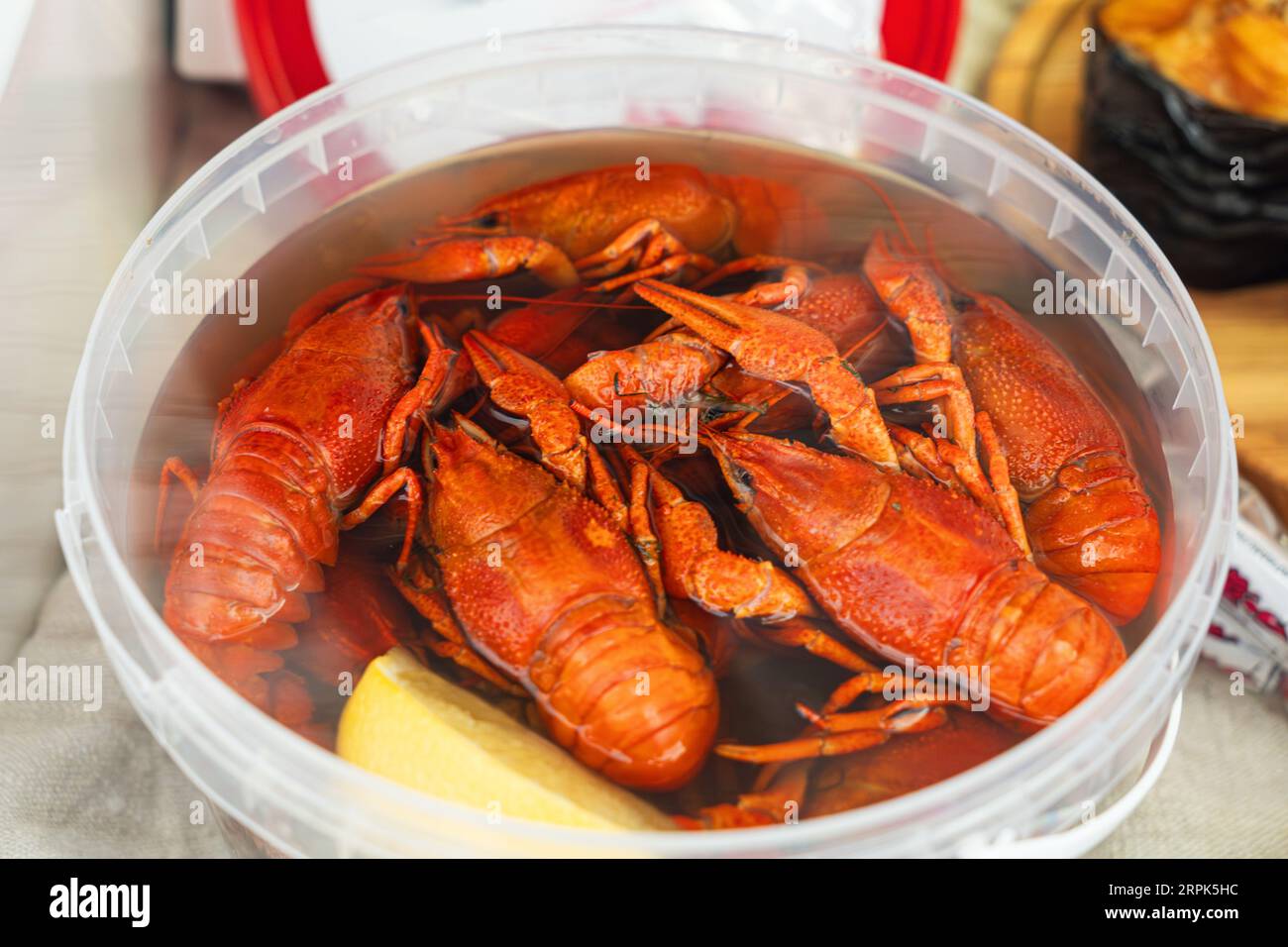cooked crawfish in saucepan with pickle water with lemons and spices ...