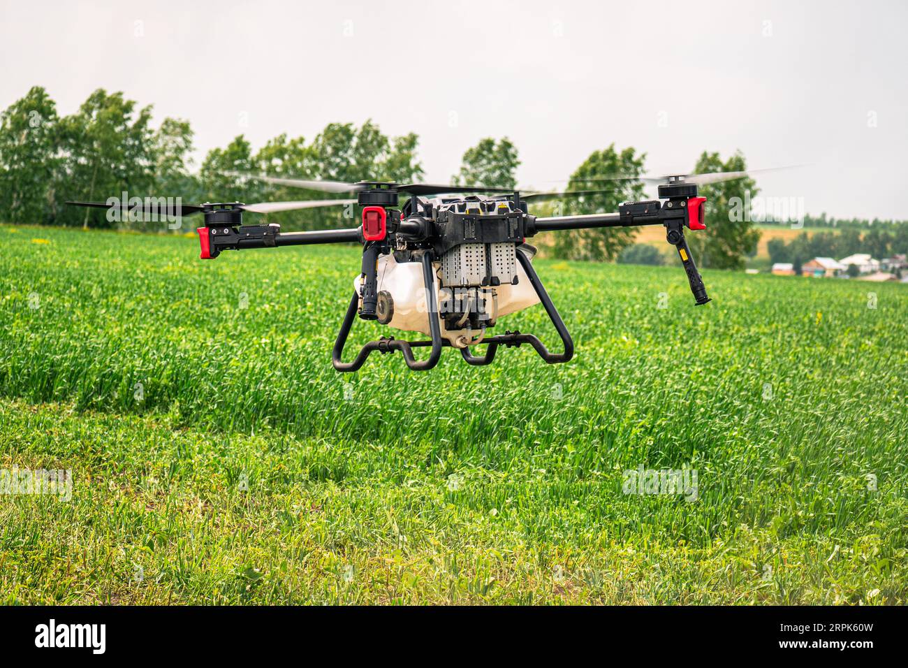 Modern technologies in agriculture. An industrial drone flies over a ...