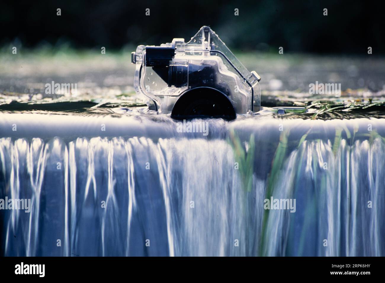 Still life of a film camera in underwater housing placed underneath a ...