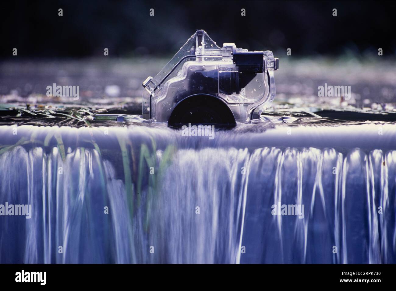 Still life of a film camera in underwater housing placed underneath a ...
