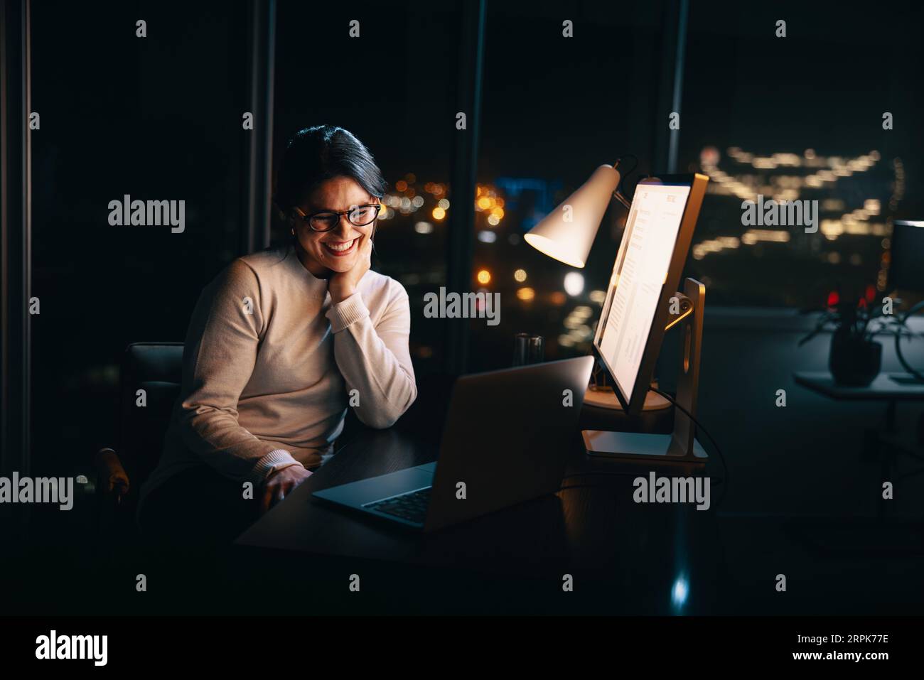 businesswoman works late from her home office, engaging in a productive ...