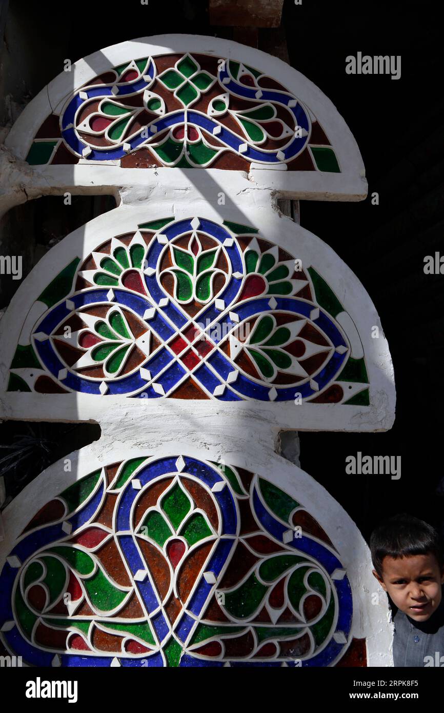 200102 -- SANAA, Jan. 2, 2020 -- A child stands by Qamaria windows ...