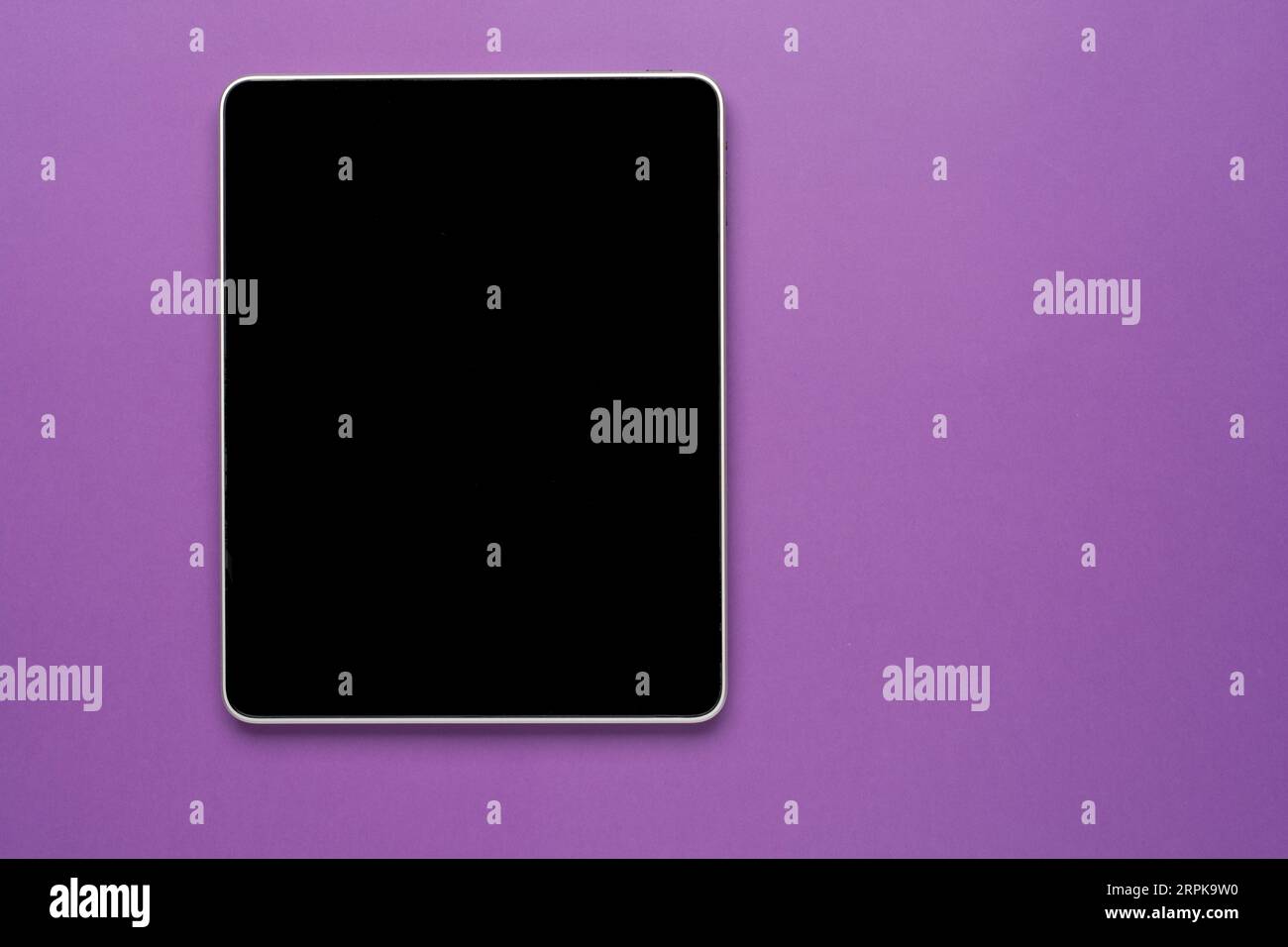 Top view of tablet on the violet pastel color background Stock Photo ...